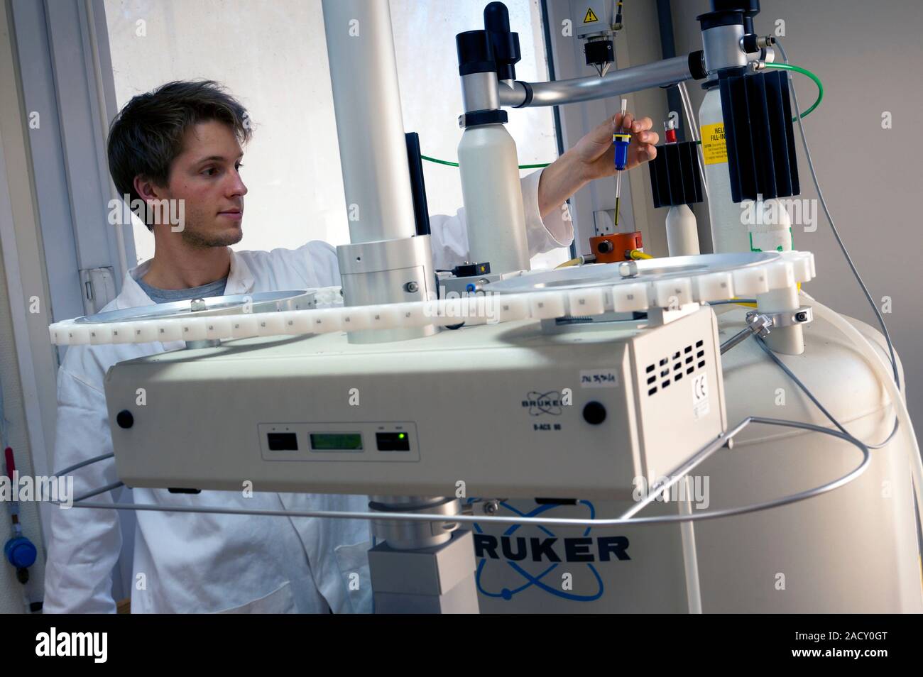 Natural product chemistry research. Laboratory technician placing plant ...