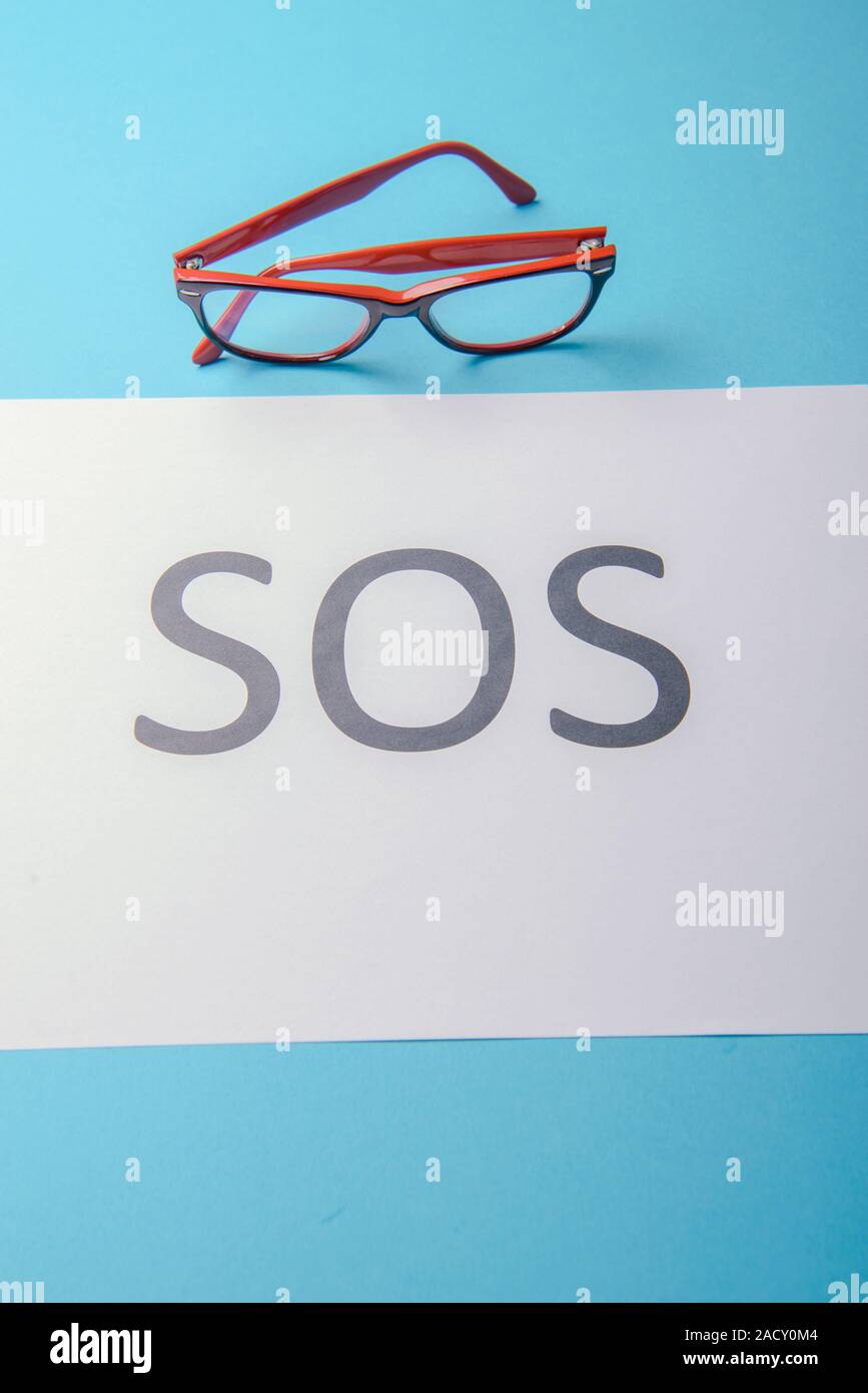 Word SOS written on white paper. Blue background Stock Photo - Alamy
