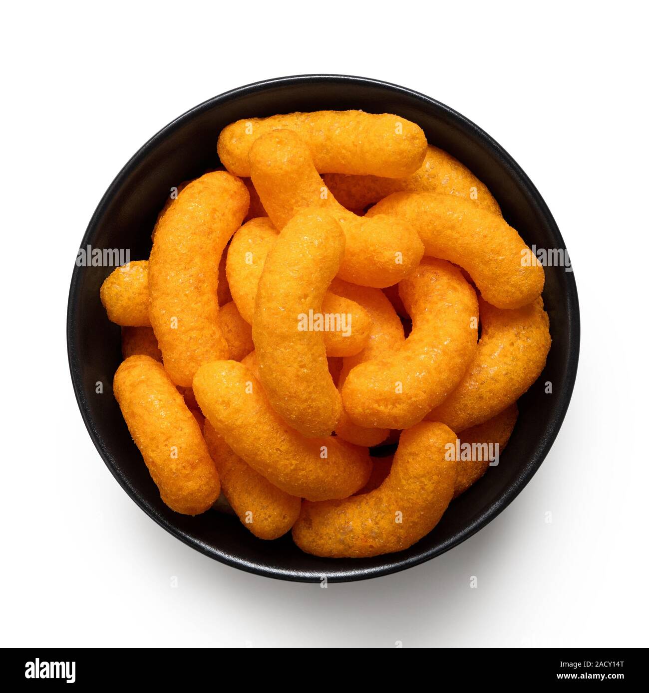 Extruded cheese puffs in a black ceramic bowl isolated on white. Top ...
