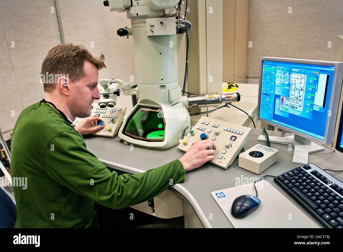 Nanomaterials research. Researcher using an advanced electron ...