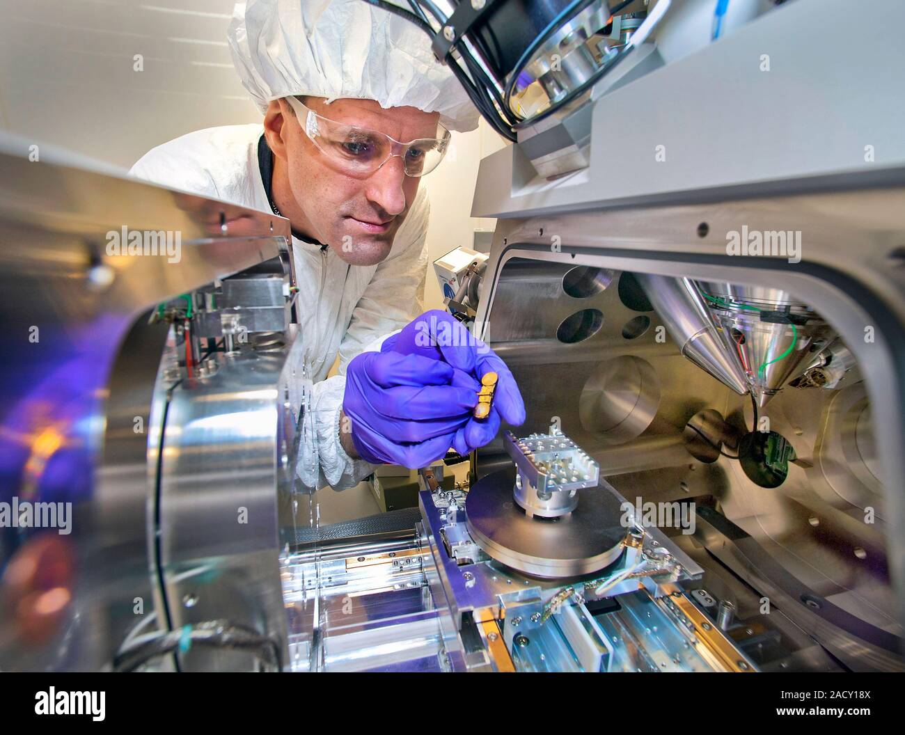 Nanomaterials research. Researcher preparing a sample of a nanomaterial ...