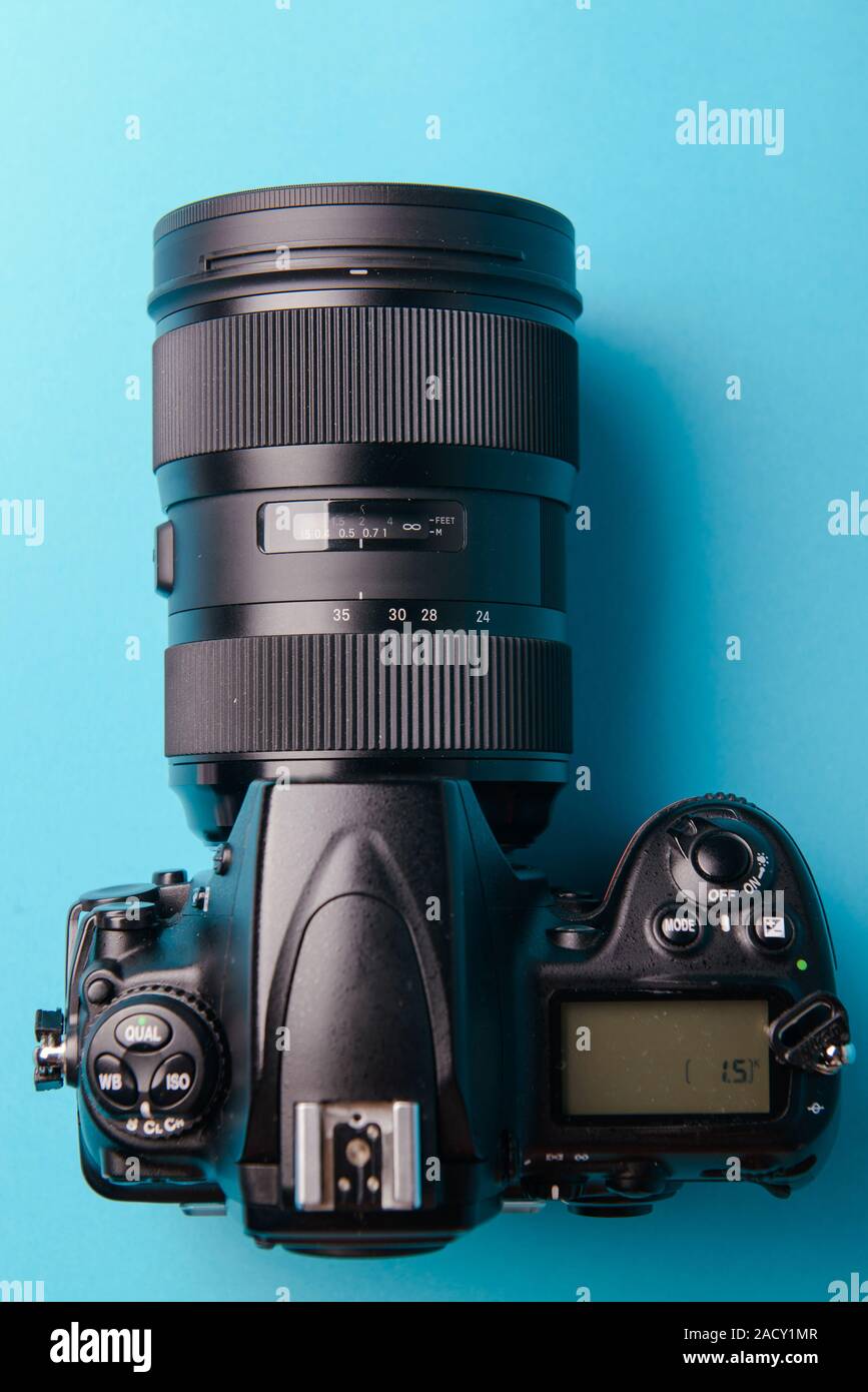 Professional modern DSLR camera against blue background Stock Photo - Alamy