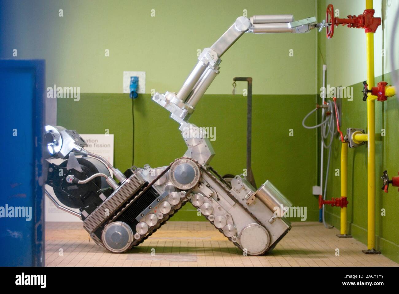 Emergency response robot opening a valve. This is the EROS robot used ...