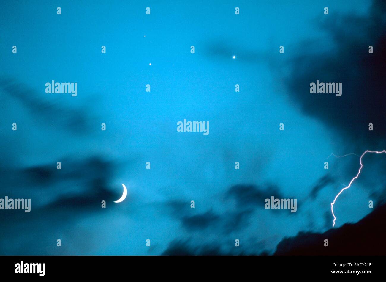 Celestial conjunction and lightning. Conjunction of the Moon (lower ...