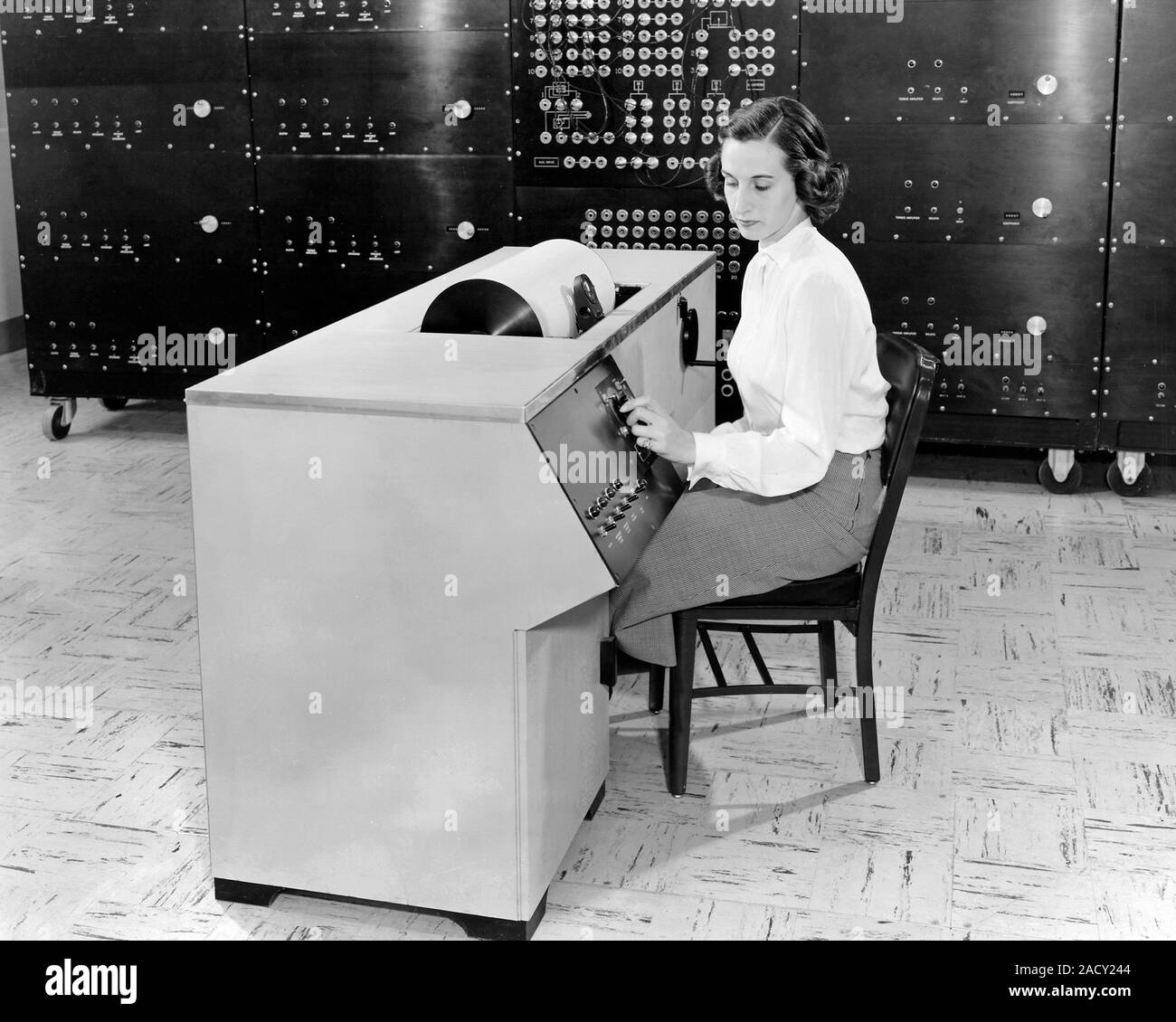 Analogue computer. Technician preparing a data report using a ...