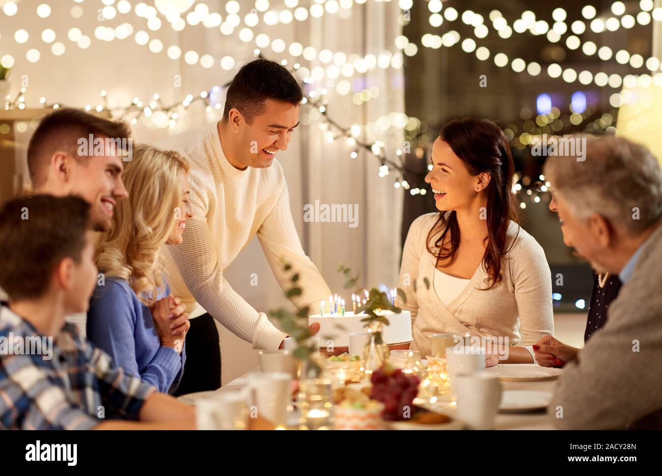 celebration and people concept - happy family with cake having birthday ...