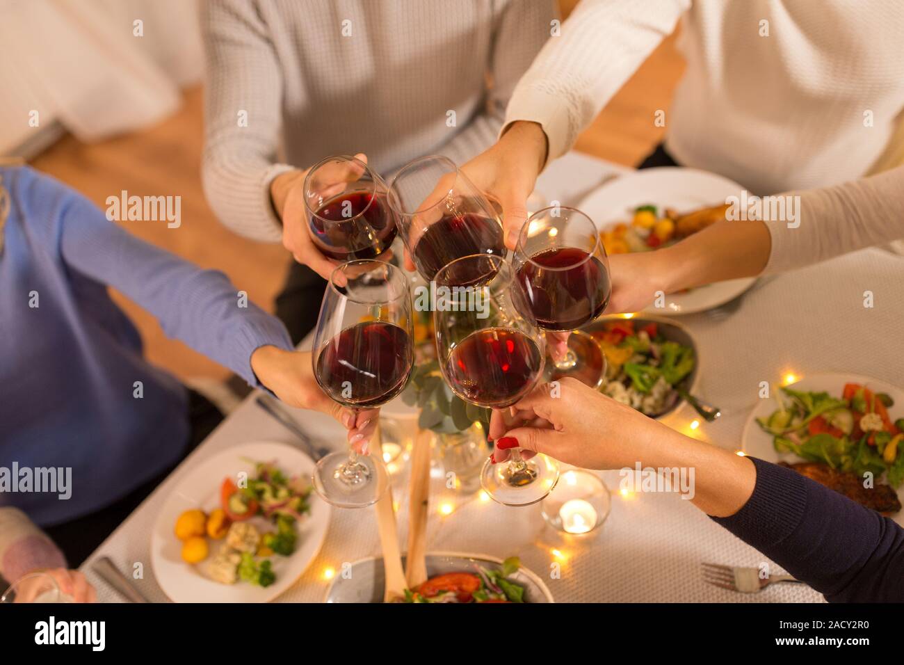 celebration, holidays and people concept - happy family having dinner party, drinking red wine ...