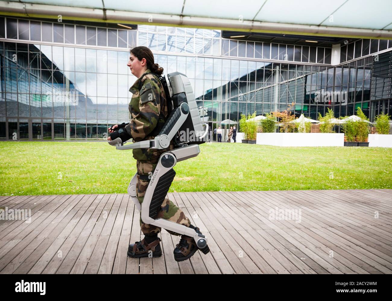 Hercule exoskeleton. Woman demonstrating the Hercule robotic ...