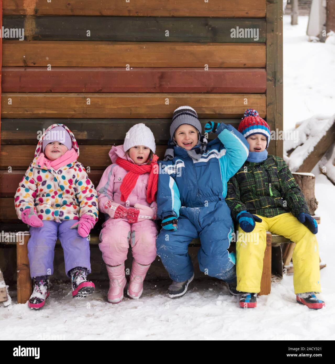 little children group sitting together in front of wooden cabin Stock ...