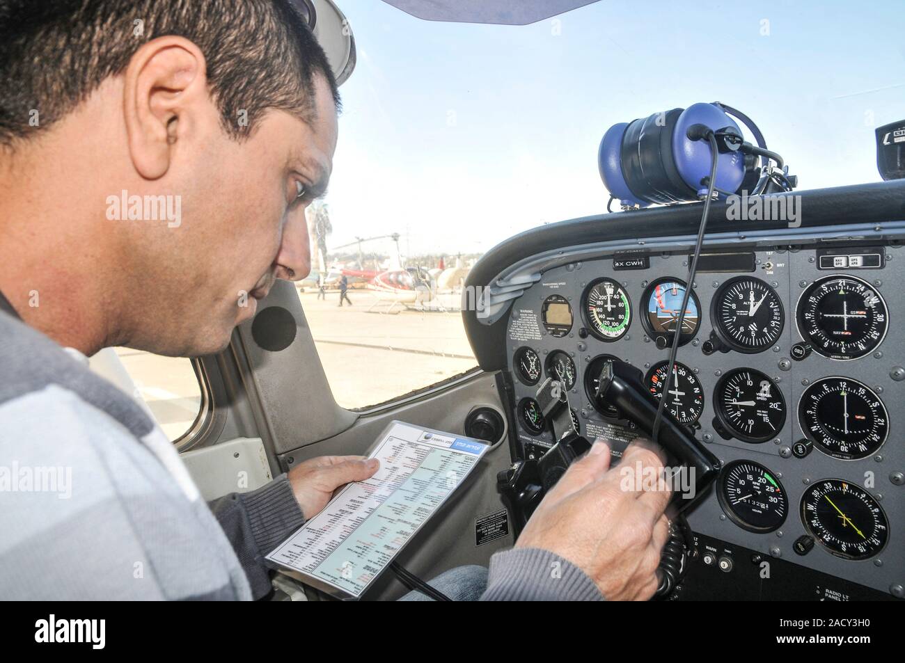 Pilot perform a preflight check on a cessna skyhawk inside the cockpit ...