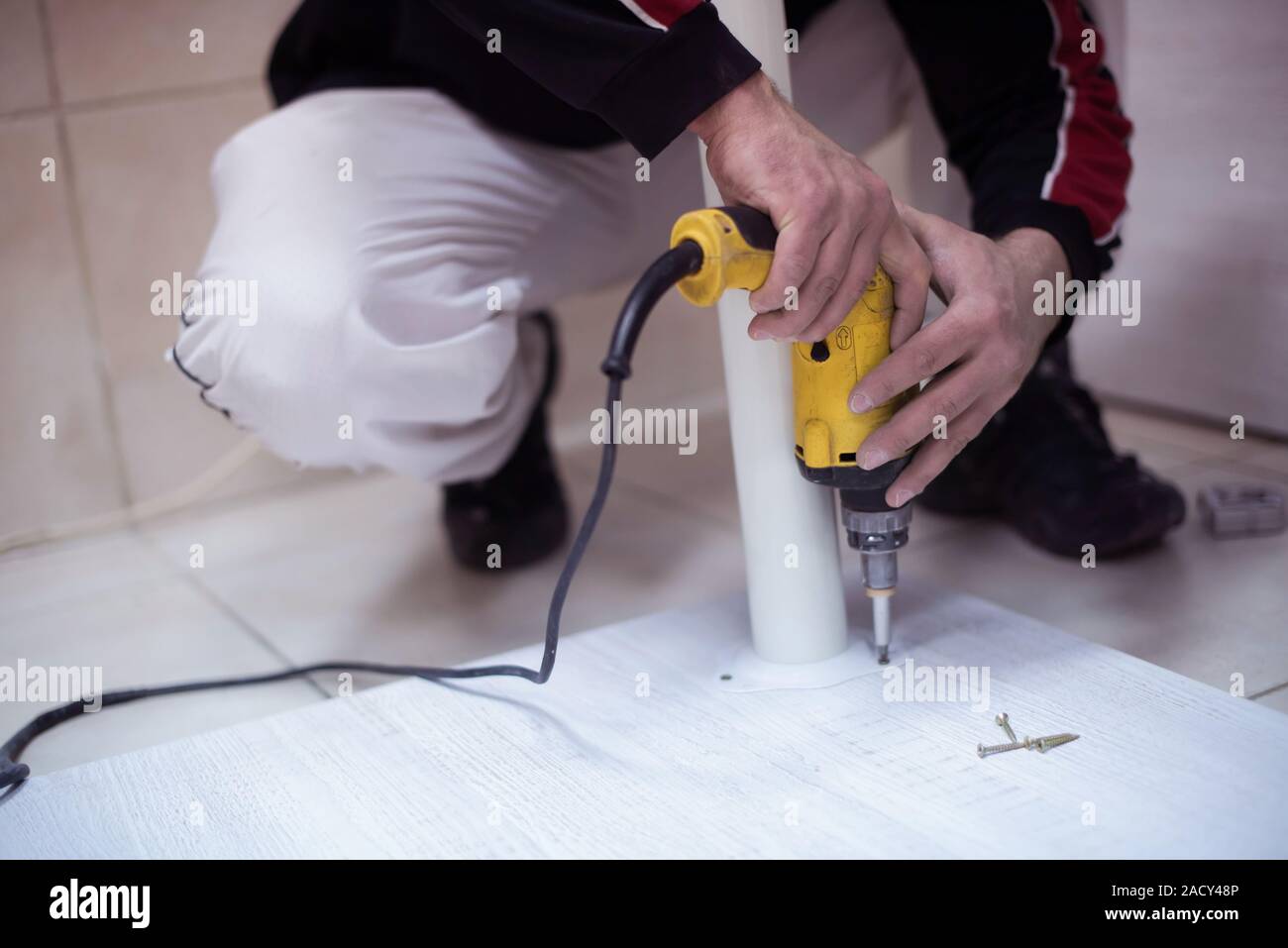 repairman working with drilling machine Stock Photo - Alamy