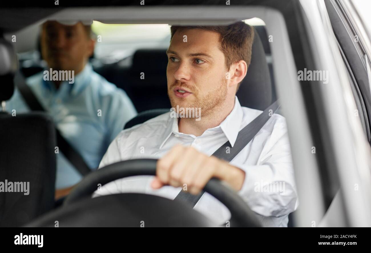 transport, vehicle and people concept - male driver driving car with ...