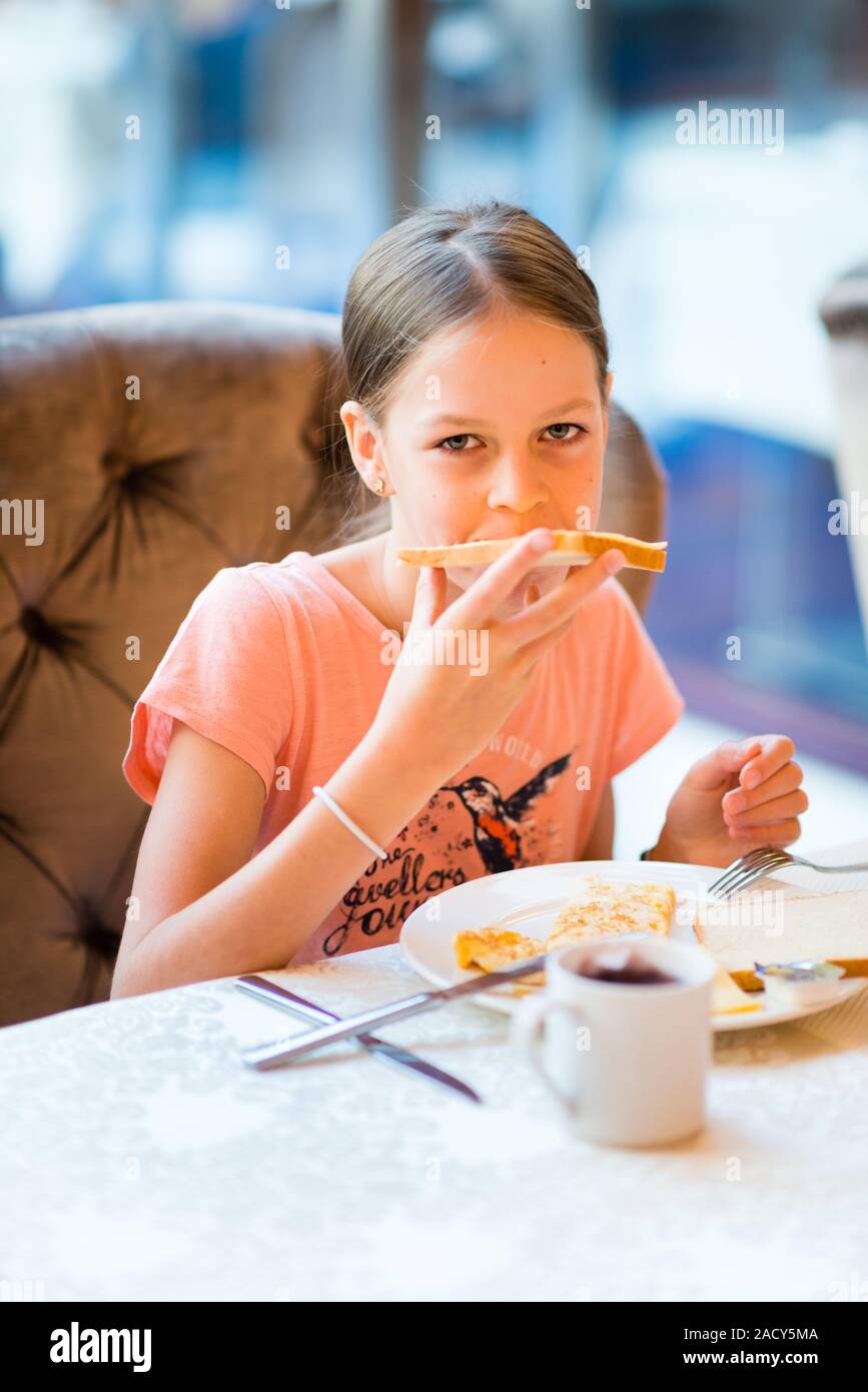 Pretty girl eating breakfast Stock Photo - Alamy