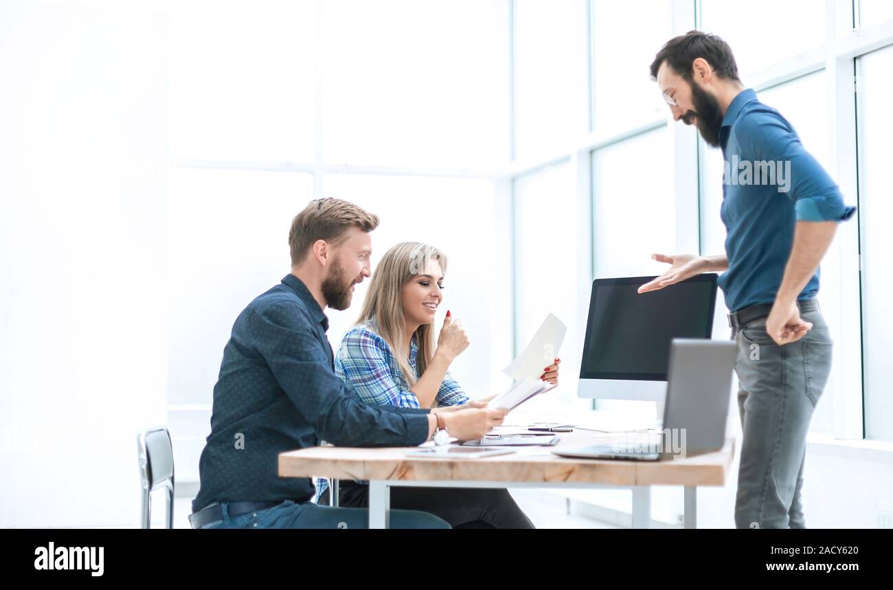 group of business people discussing something near the office Desk ...