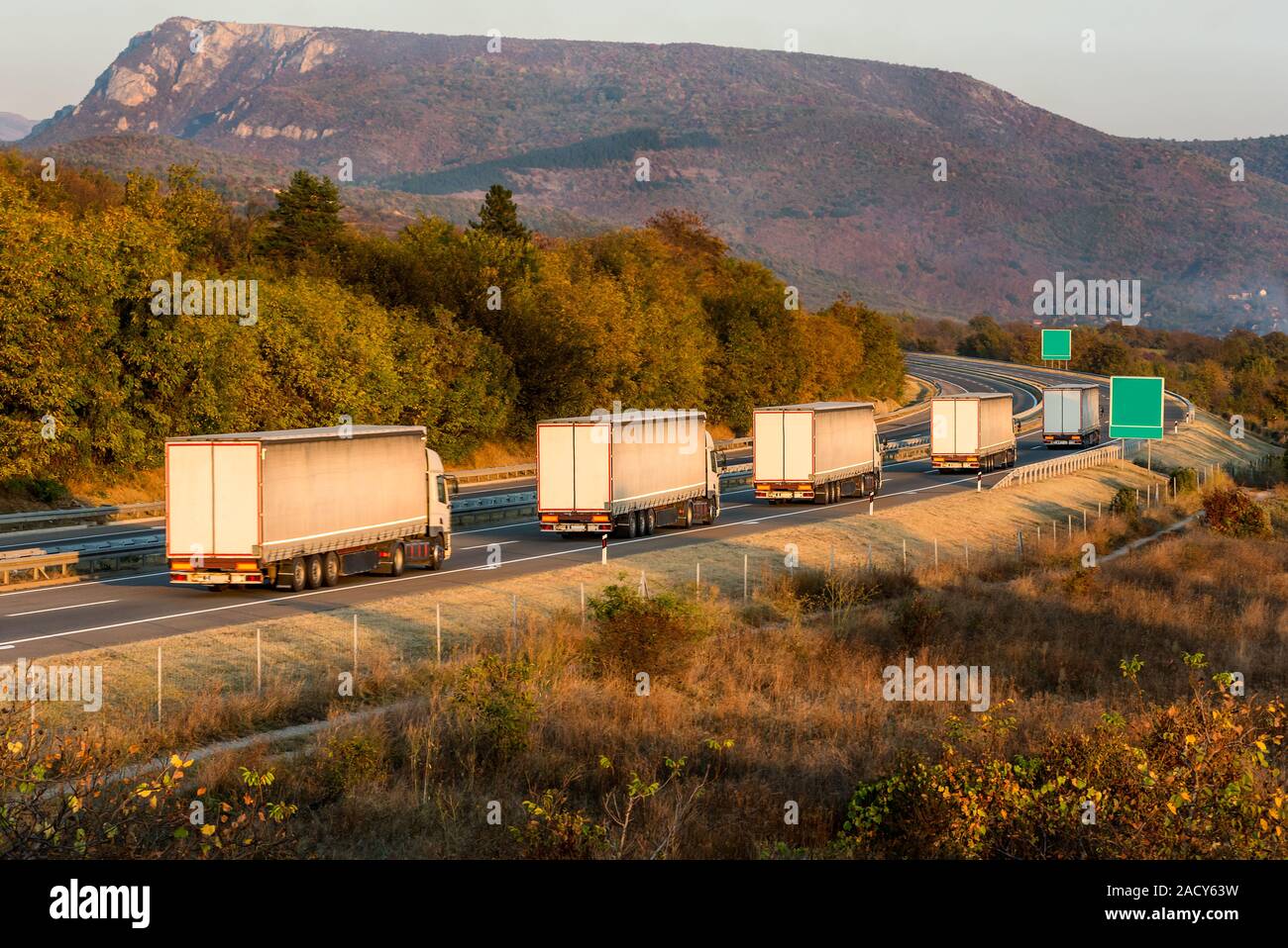 White trucks on a highway. Highway transportation with white lorry ...