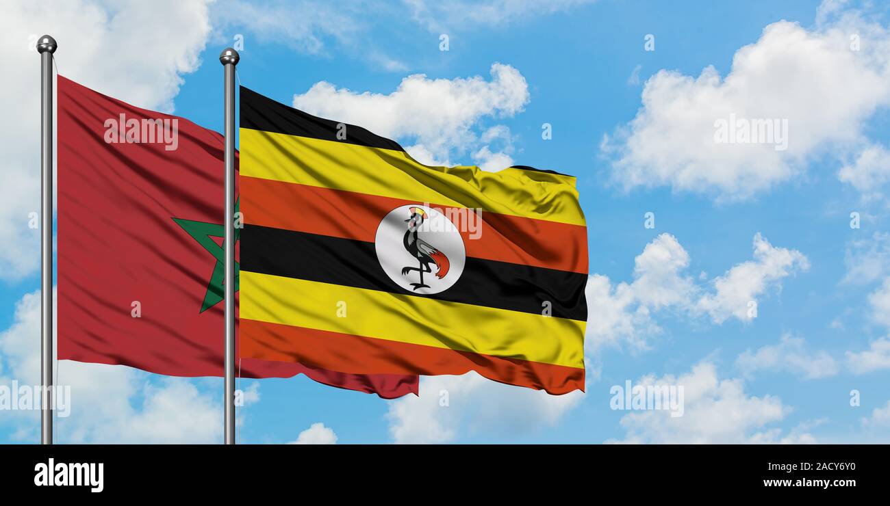 Morocco and Uganda flag waving in the wind against white cloudy blue ...