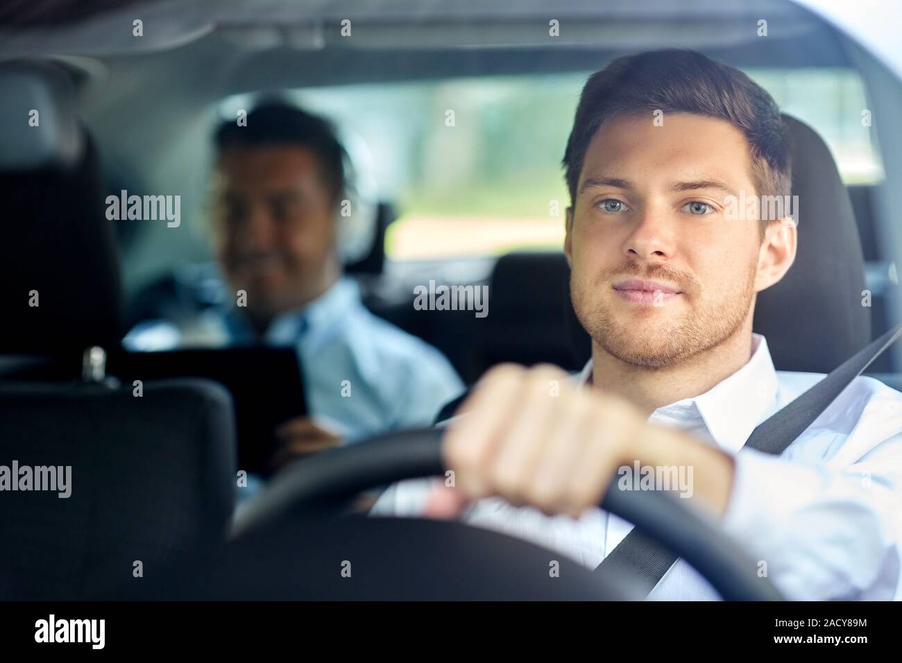 transport, people and taxi concept - male driver driving car with ...