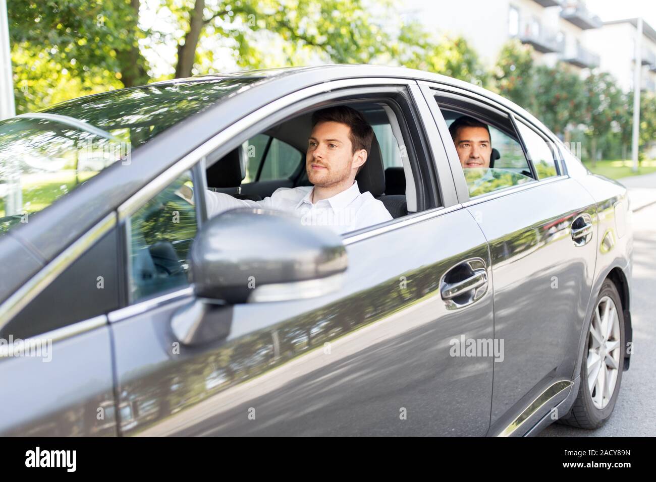 transport, vehicle and people concept - male driver driving car with ...