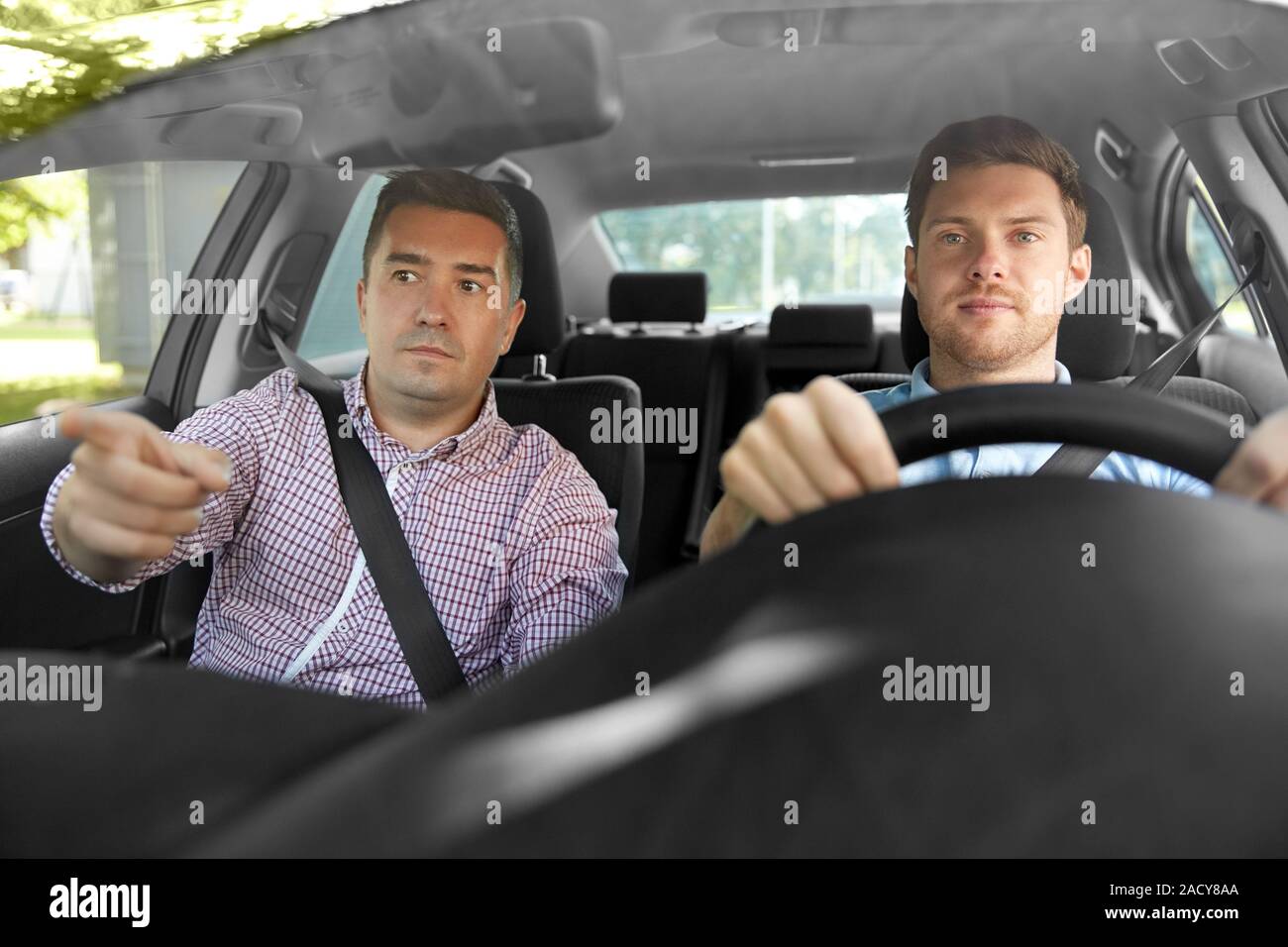 driver courses and people concept - car driving school instructor ...