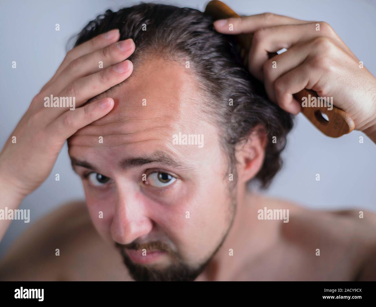Portrait of a young guy with magnificent hair that falls early on his ...