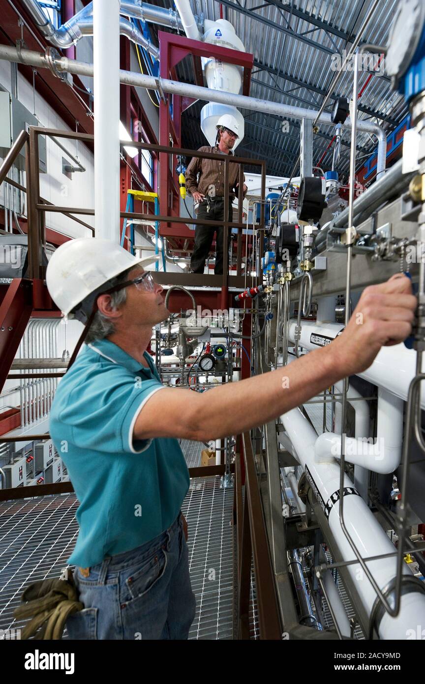 Biomass pre-treatment reactor. Workers with the pre-treatment reactor ...