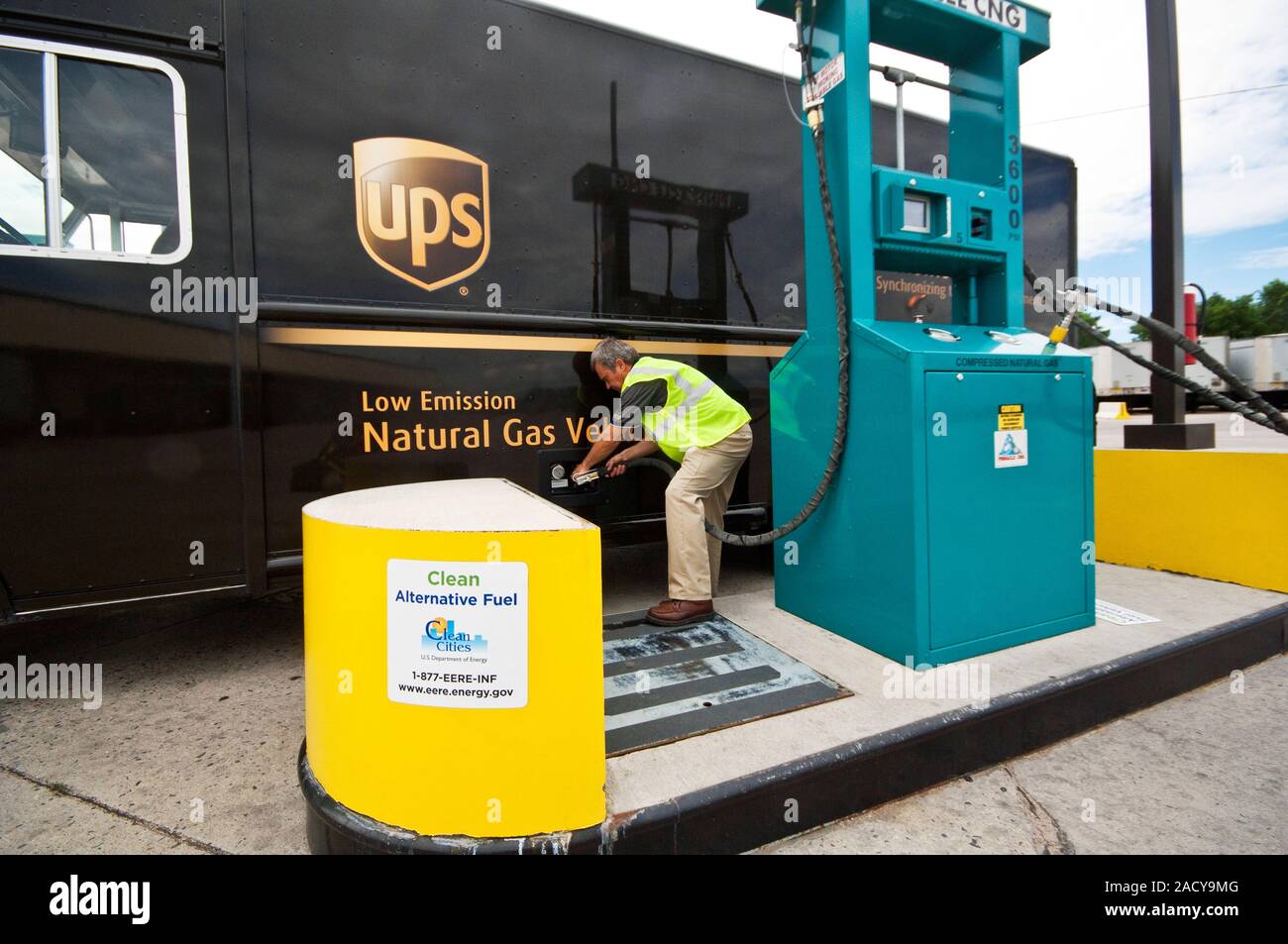 Compressed natural gas-powered vehicle. Delivery driver filling his van ...