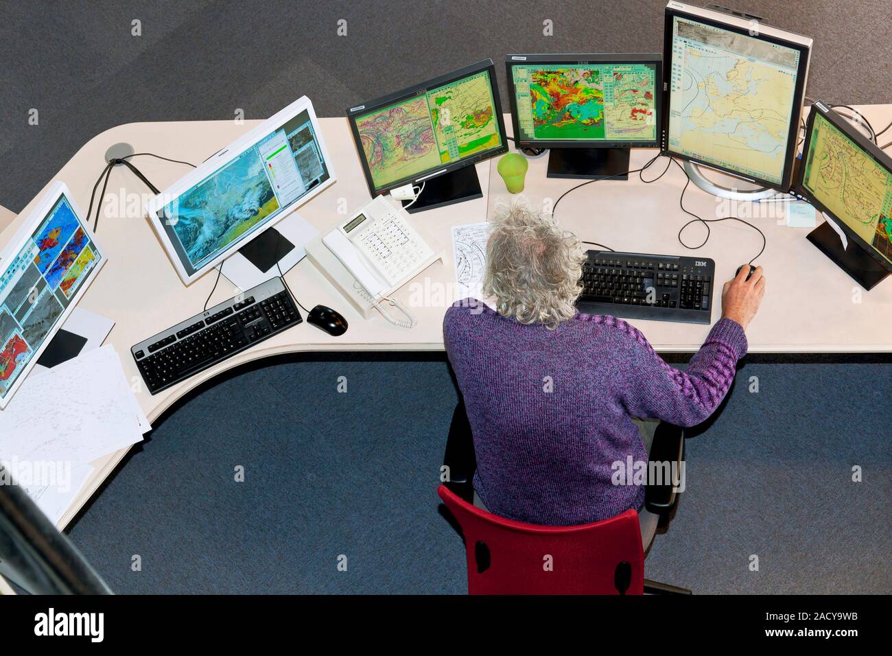 Weather forecasting. Meteorologist studying meteorological maps and ...