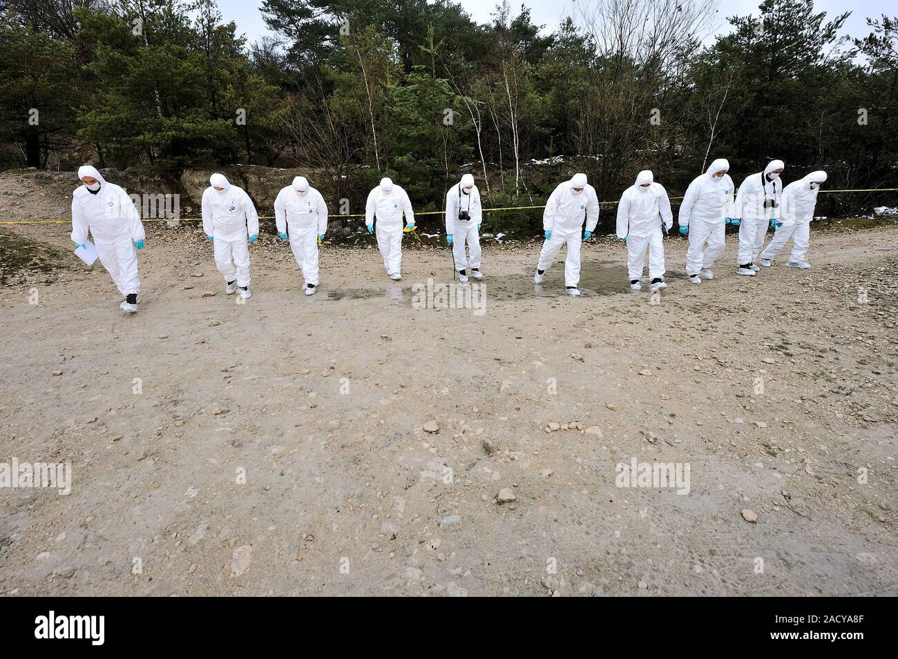 Policeman undergoing forensic training. They are conducting a search of ...