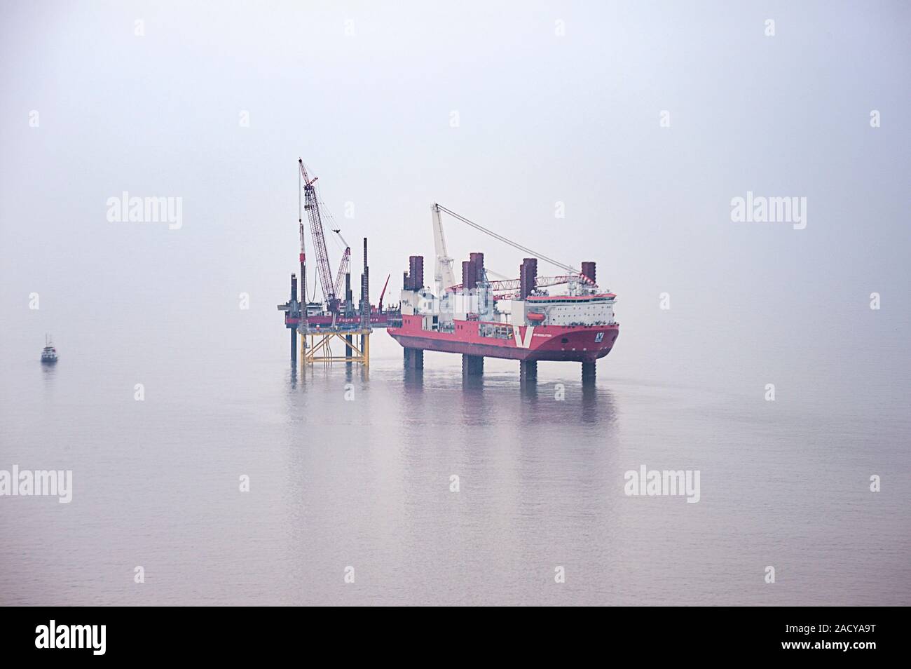 Offshore wind farm construction, aerial photograph. A jack-up barge is ...