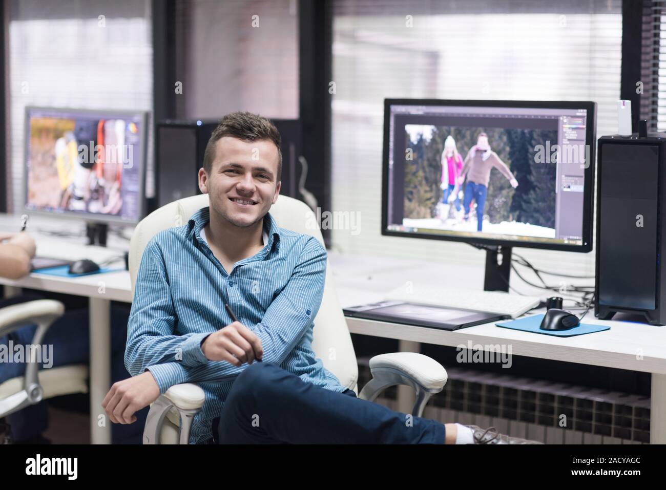 photo editor at his desk Stock Photo - Alamy