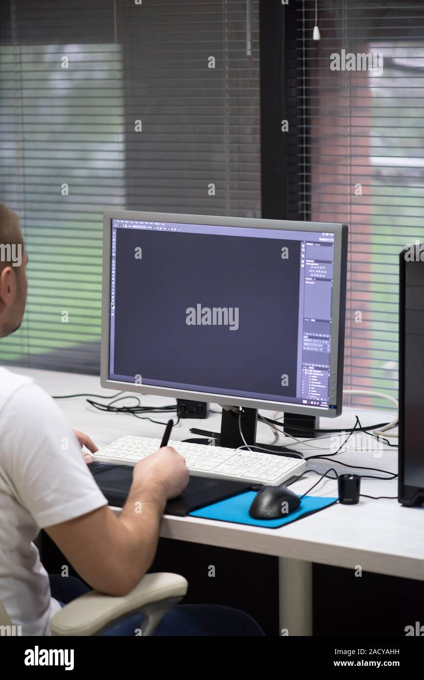 photo editor at his desk Stock Photo - Alamy