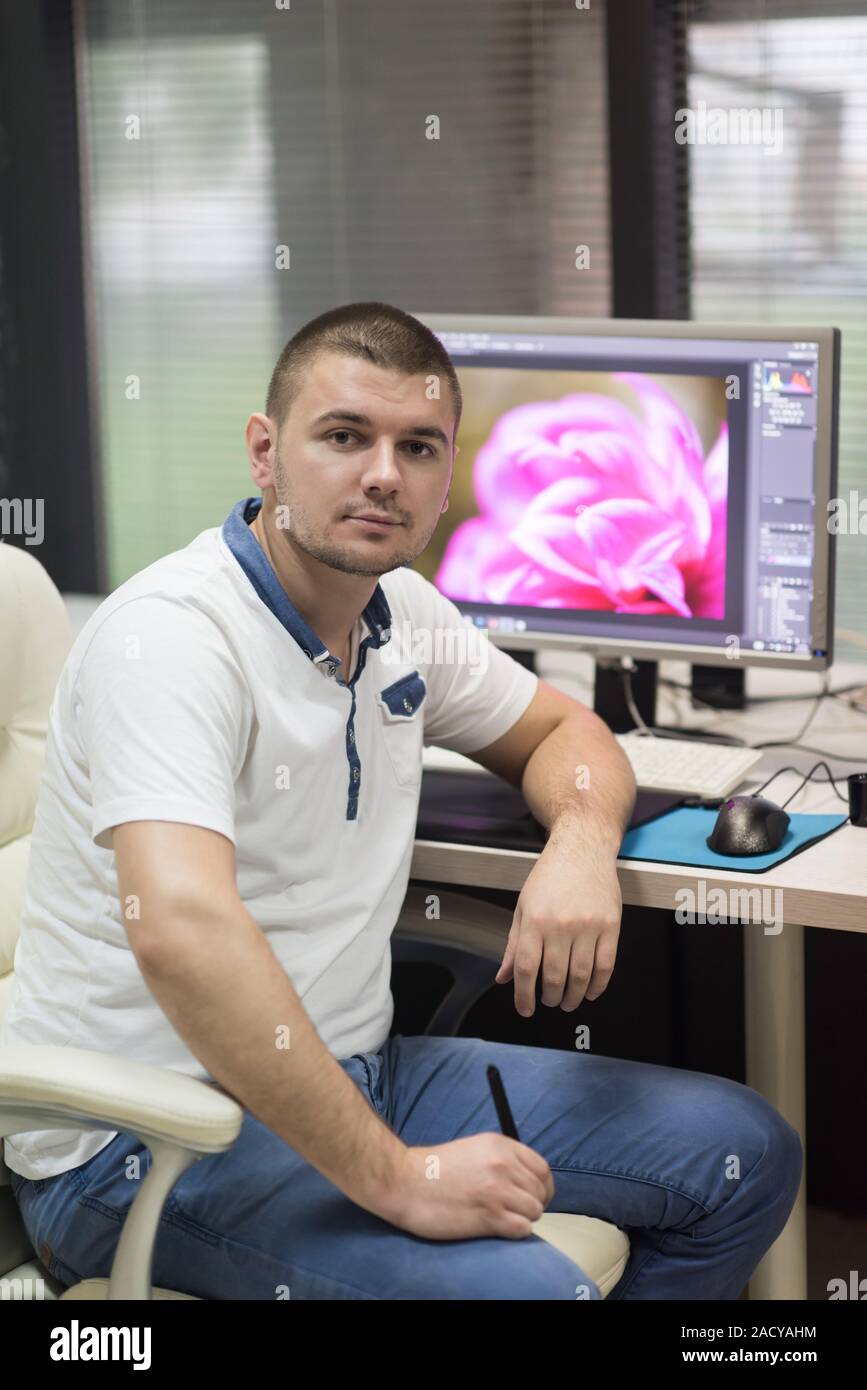 photo editor at his desk Stock Photo - Alamy