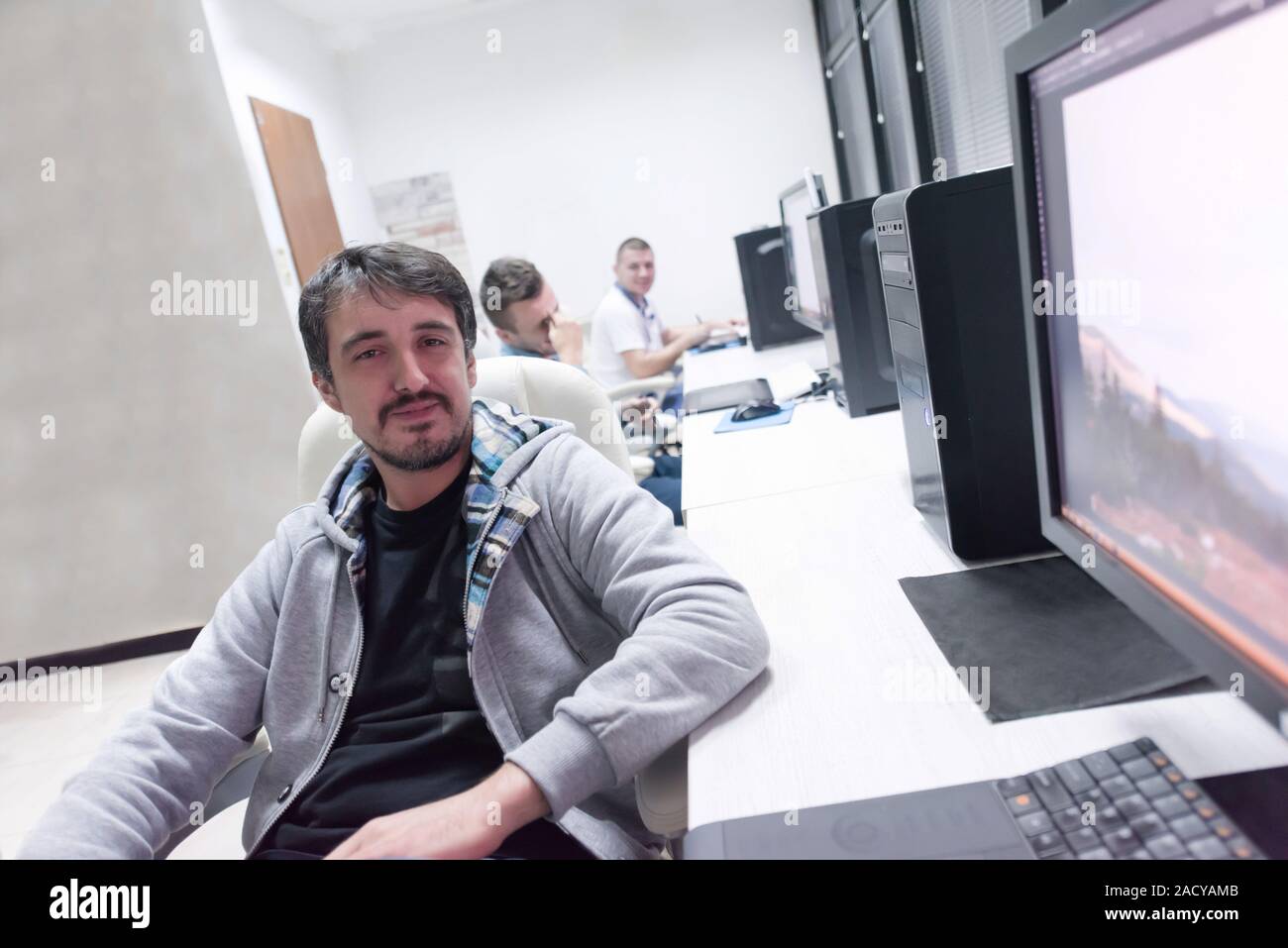 photo editor at his desk Stock Photo - Alamy