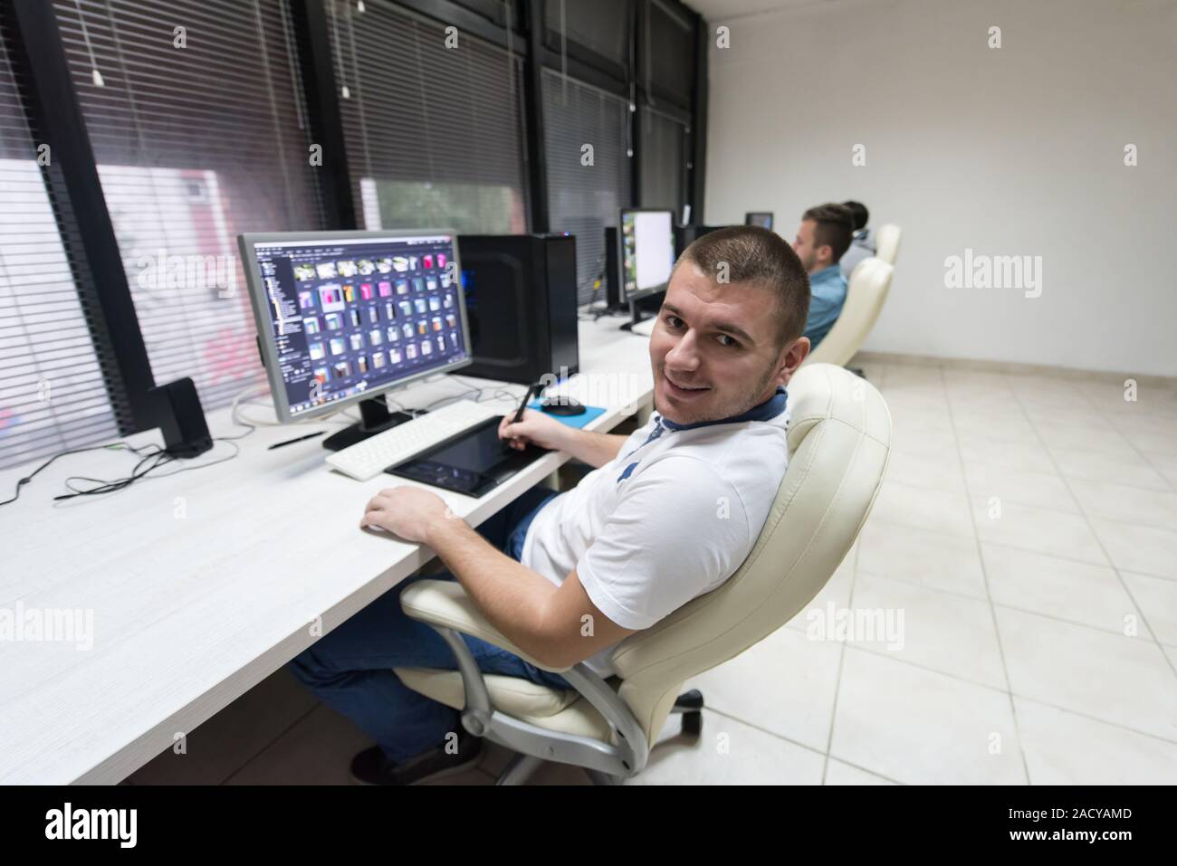 photo editor at his desk Stock Photo - Alamy