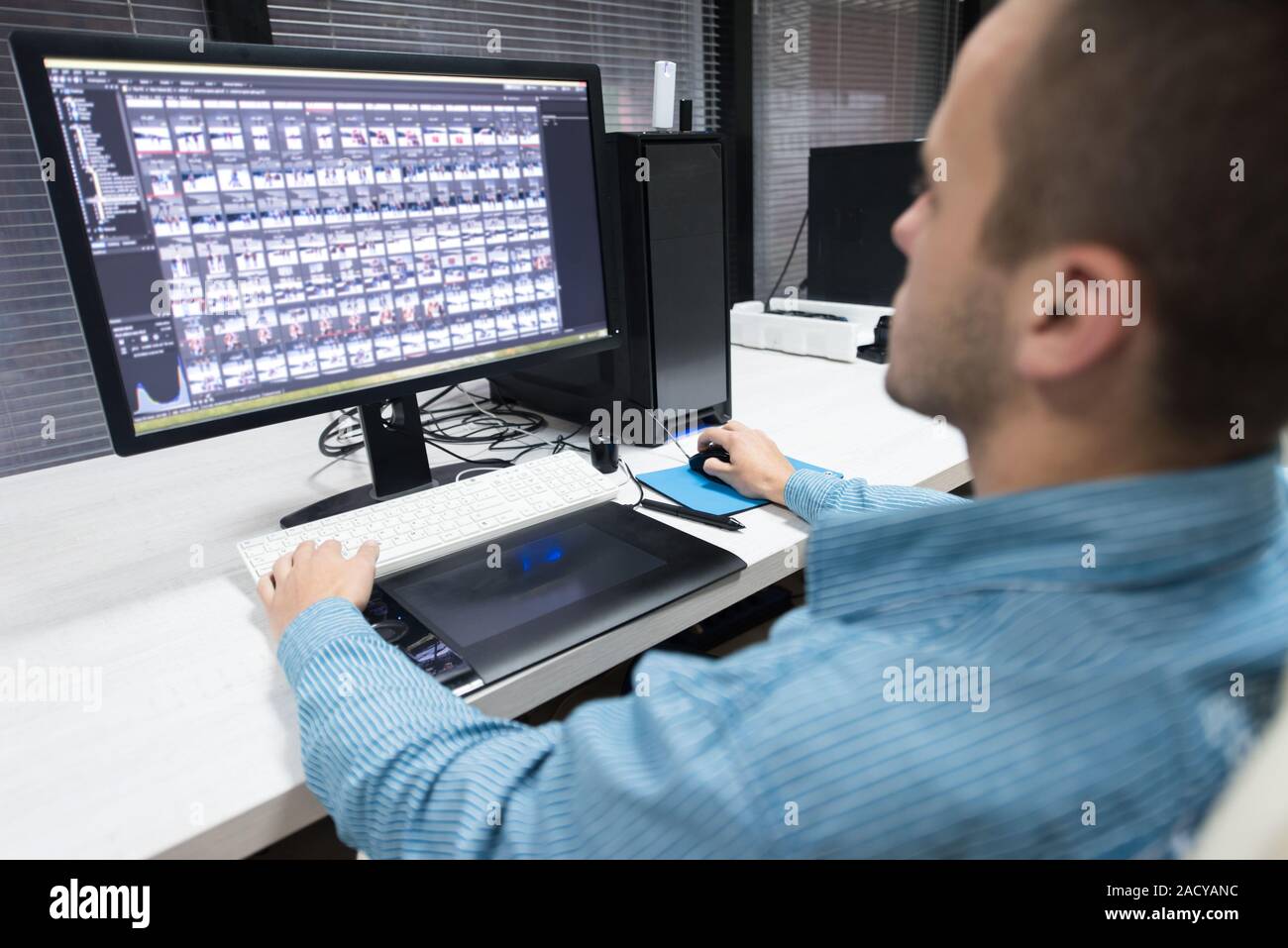 photo editor at his desk Stock Photo - Alamy