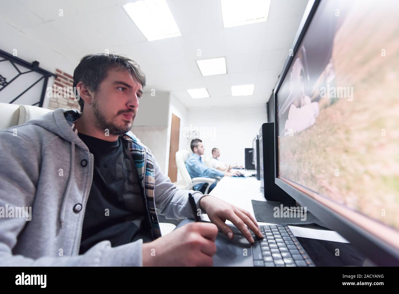 photo editor at his desk Stock Photo - Alamy