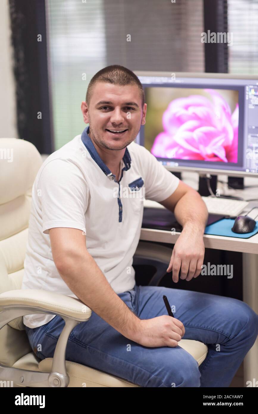 photo editor at his desk Stock Photo - Alamy