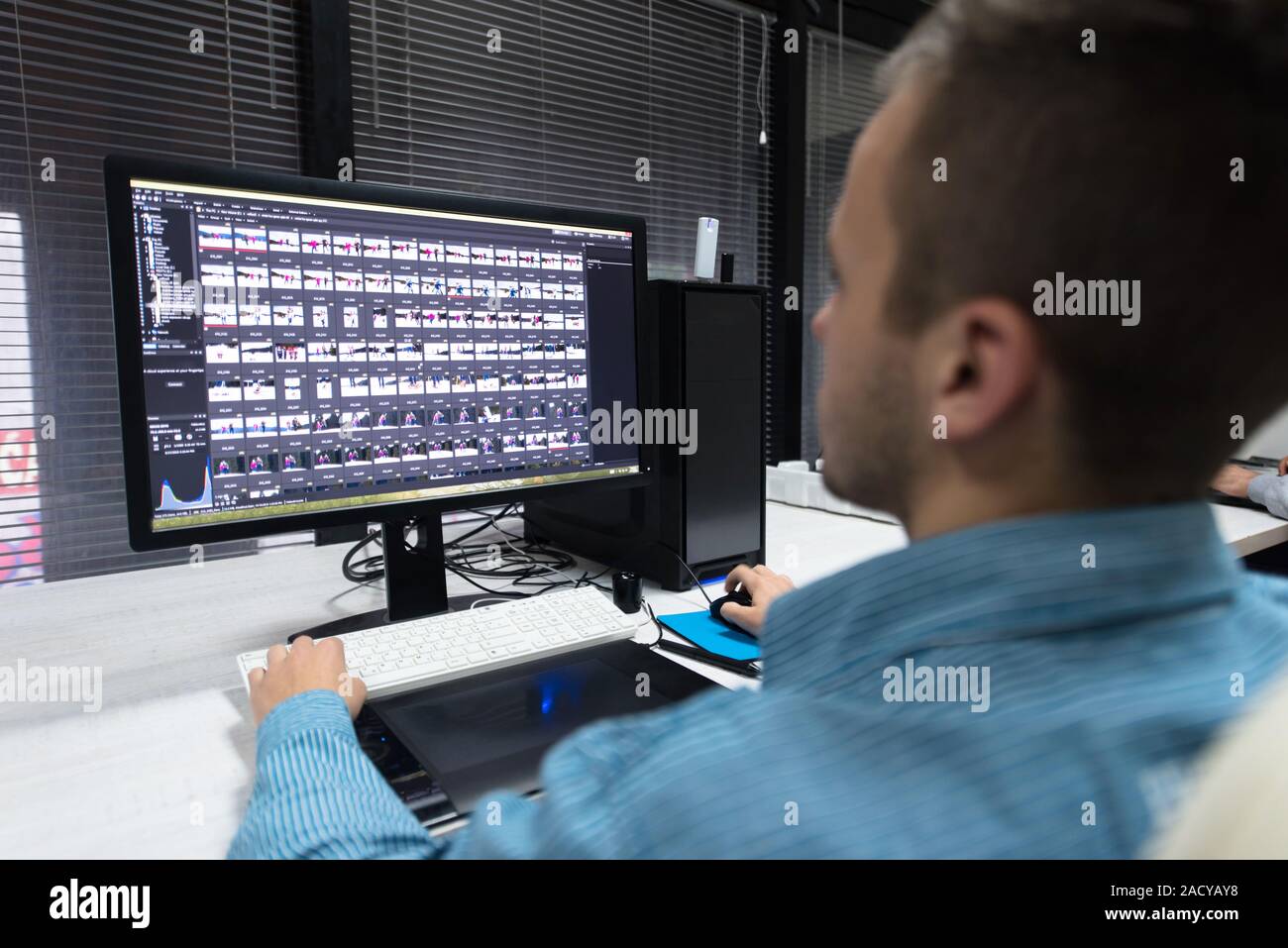 photo editor at his desk Stock Photo - Alamy