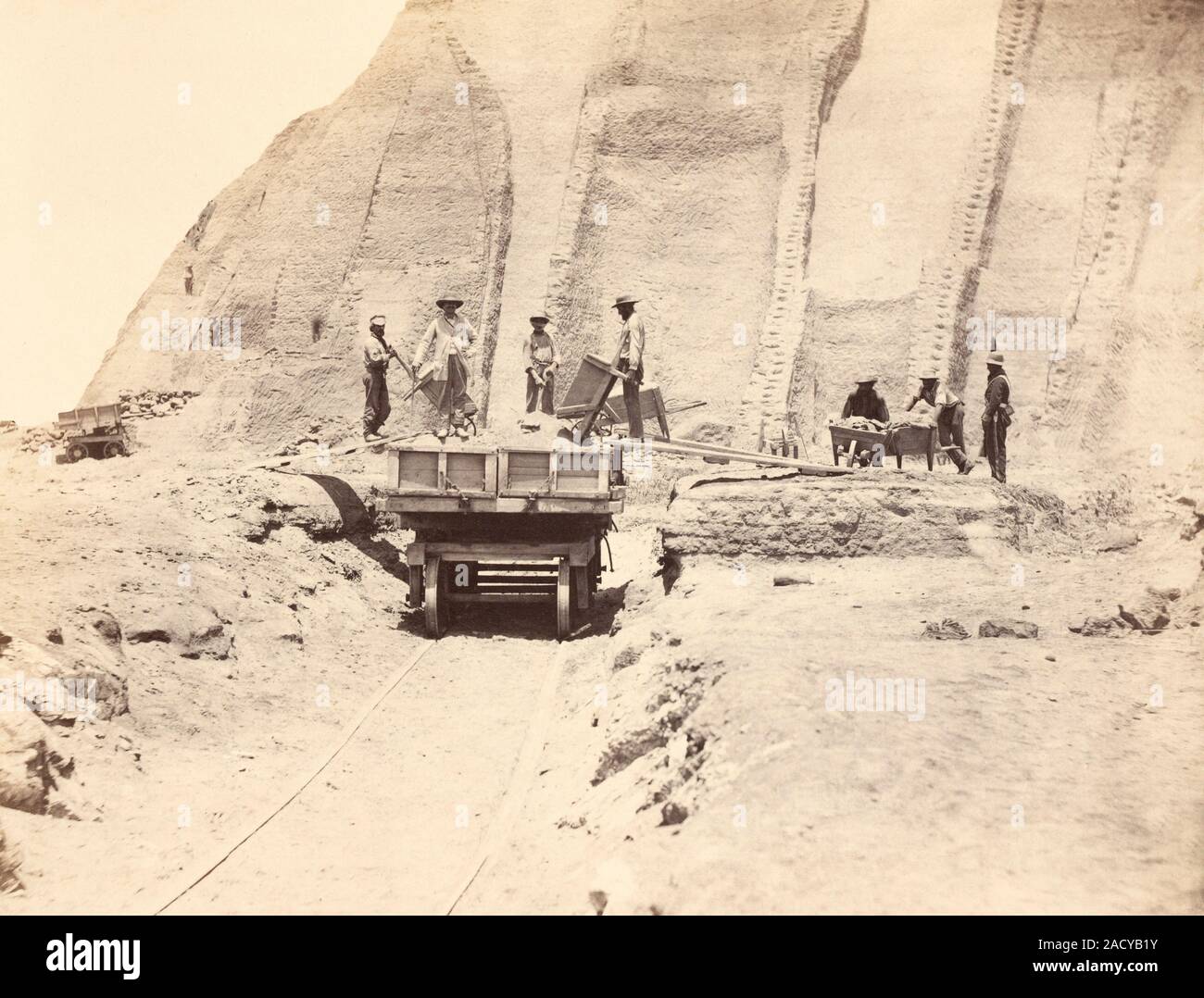 Guano extraction. Men loading cars with guano at the Great Heap - a ...