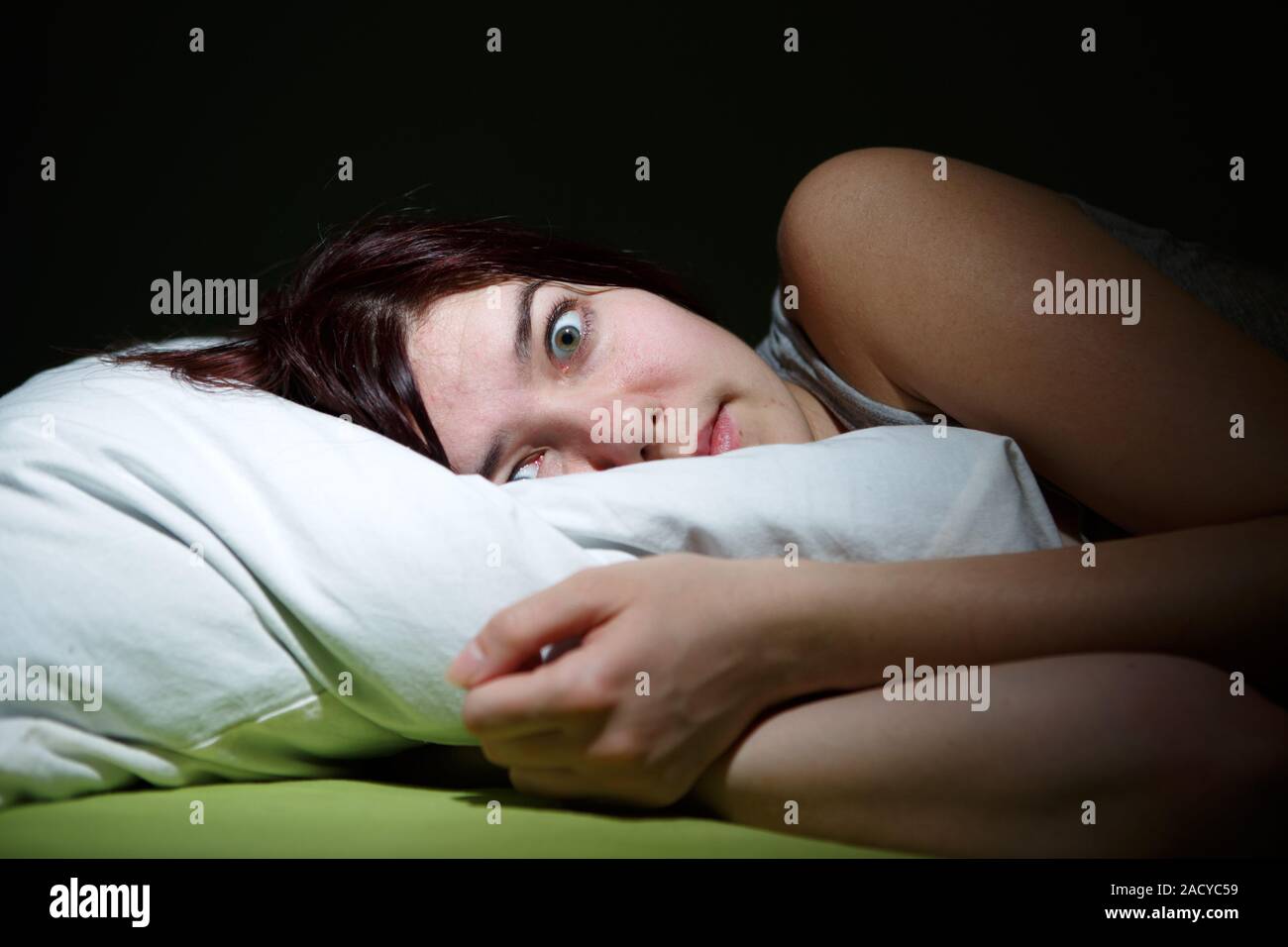 Woman scared in bed at night hi-res stock photography and images - Alamy