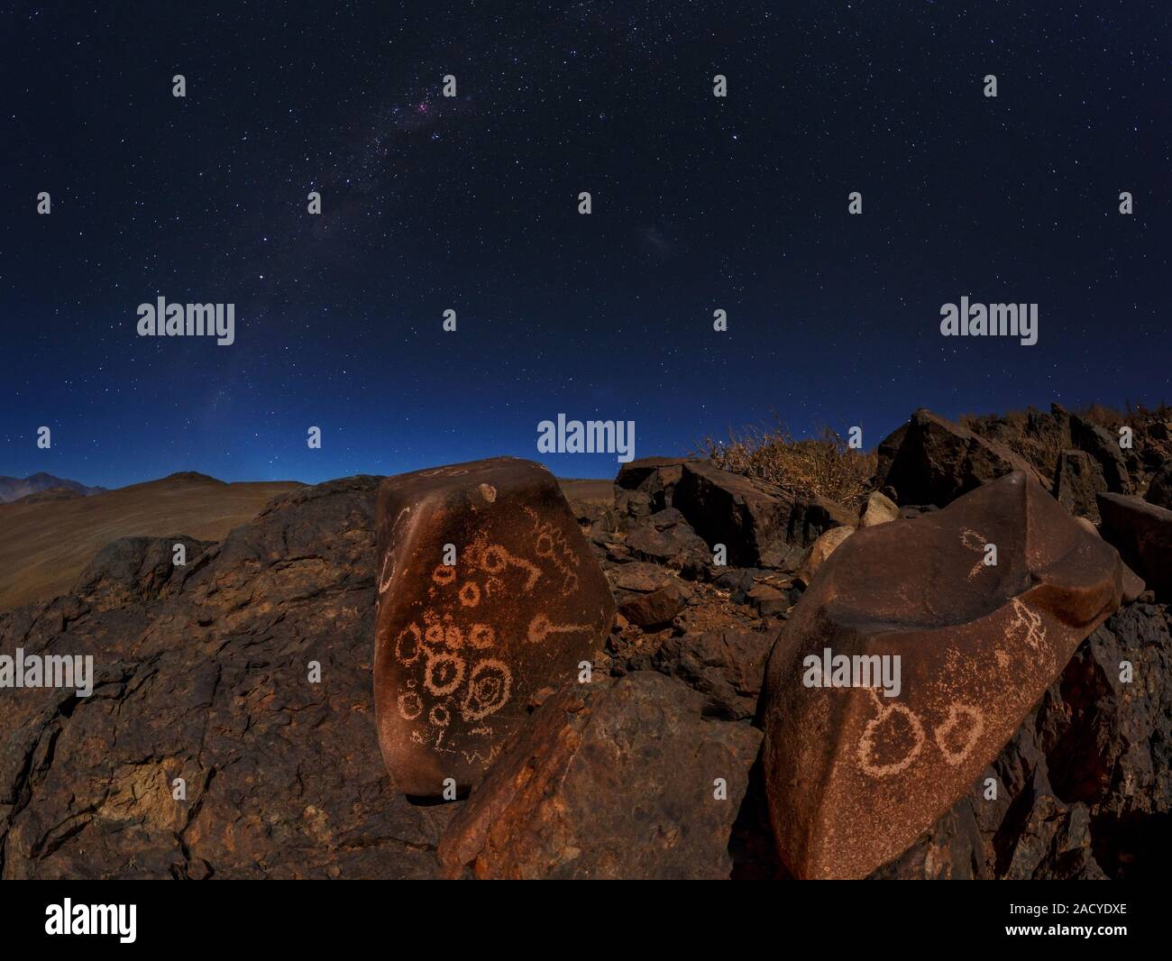 Milky Way over petroglyphs. View across ancient rock art towards the ...