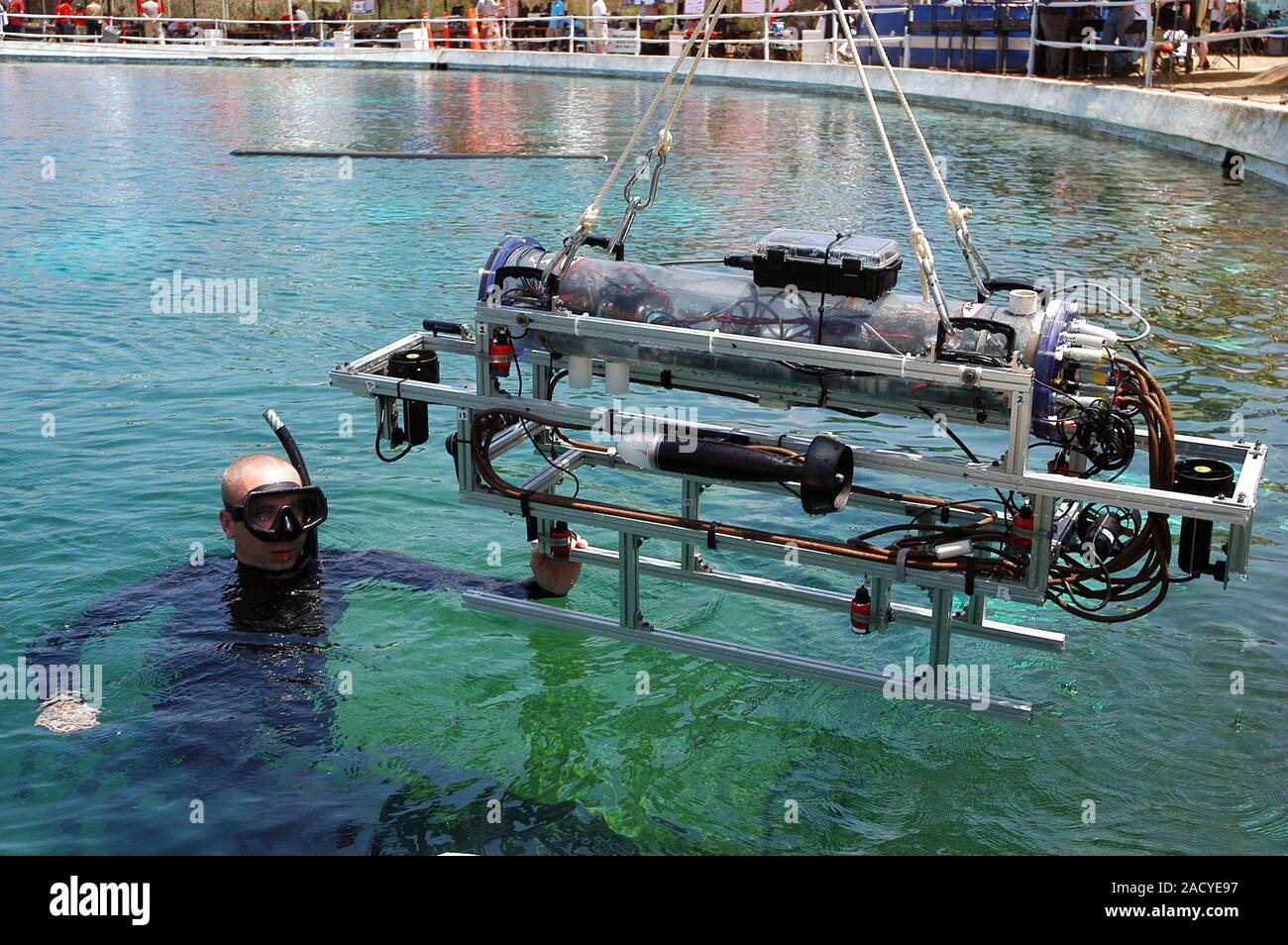 Underwater autonomous robot. A navy diver monitors an unmanned robotic ...