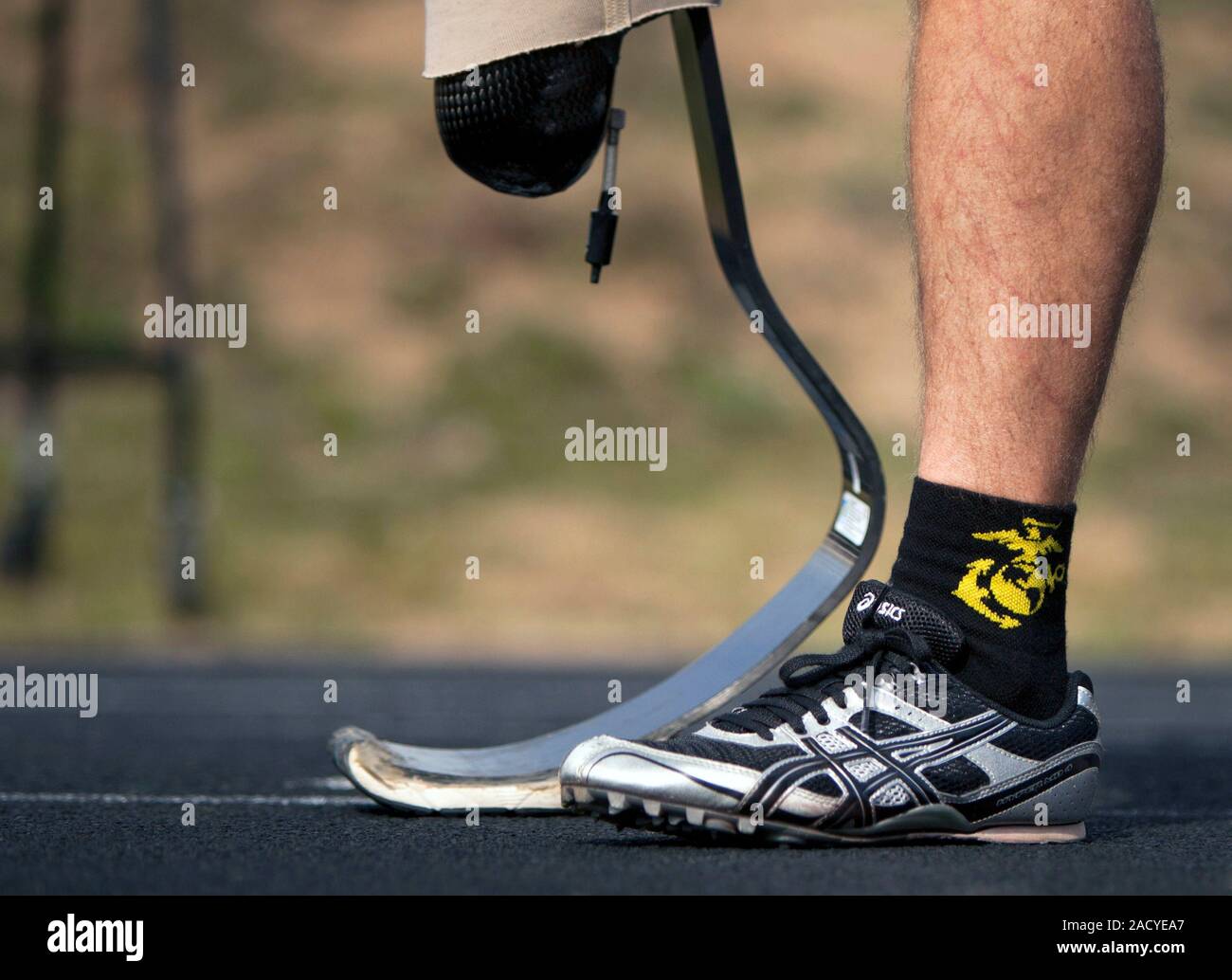 Amputee sprinter. View of the legs of a sprinter before the start of ...