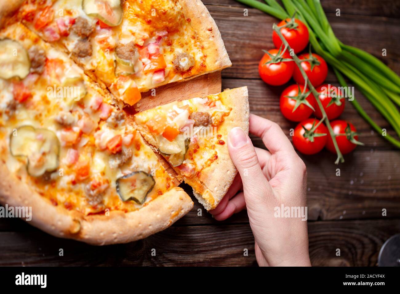 Hand holding pizza slice hi-res stock photography and images - Alamy