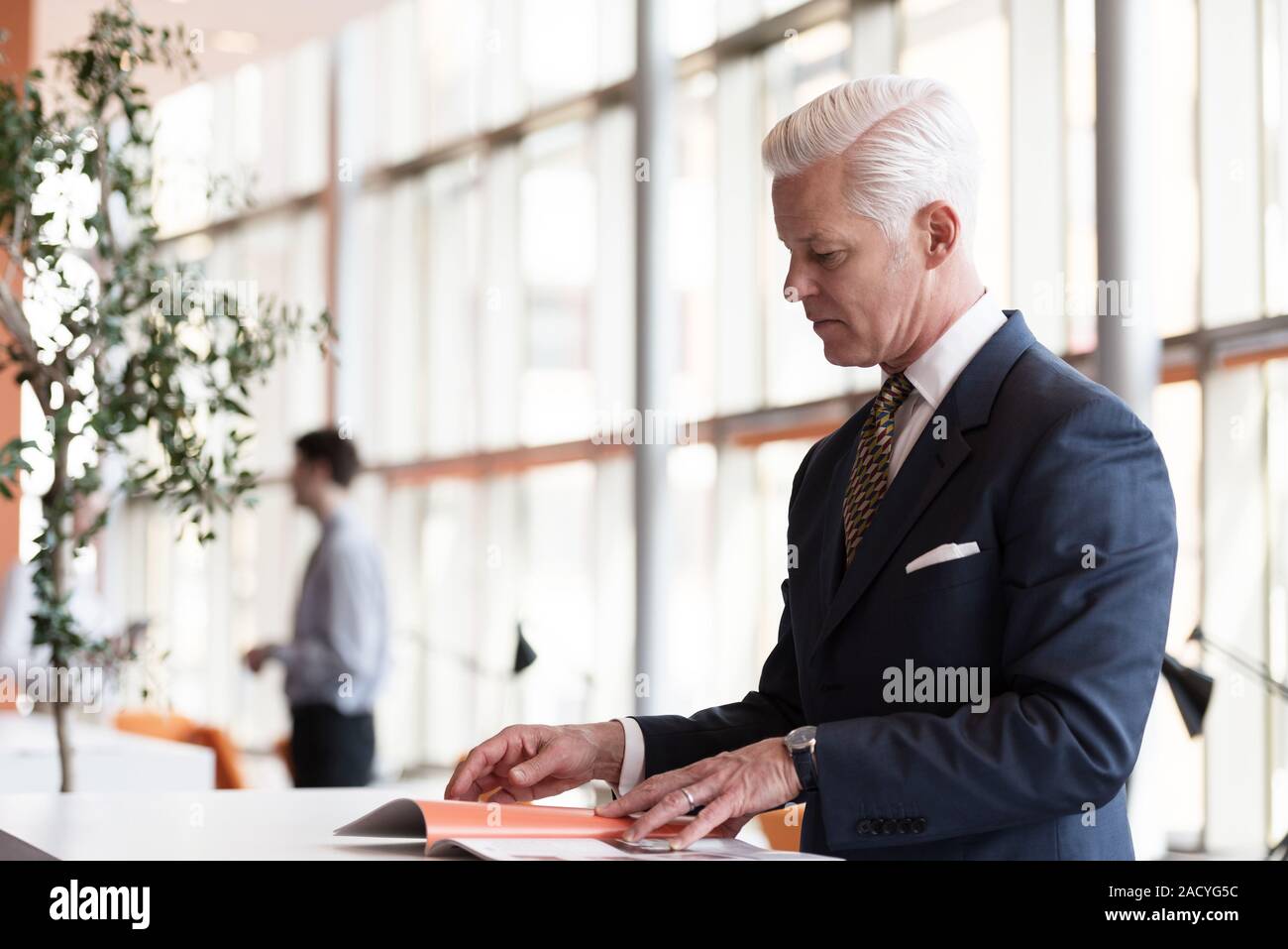 Successful businessman reading magazine hi-res stock photography and ...