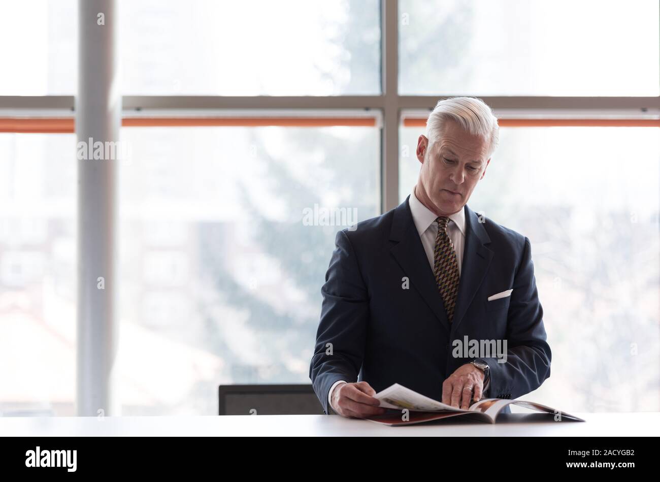 senior Business man reading magazine Stock Photo - Alamy
