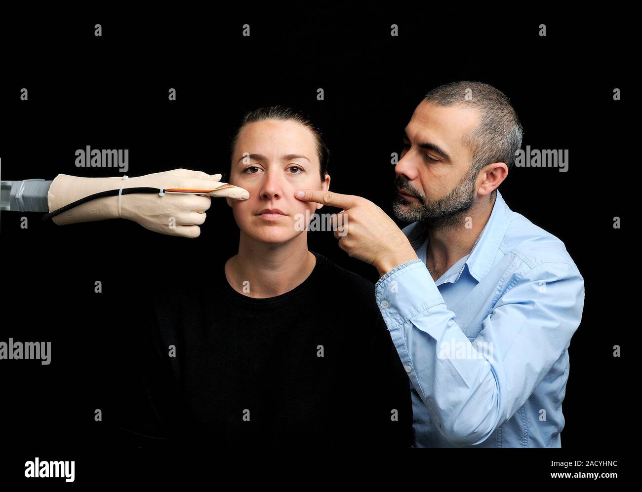 Measuring skin softness. Researcher using an artificial finger equipped ...
