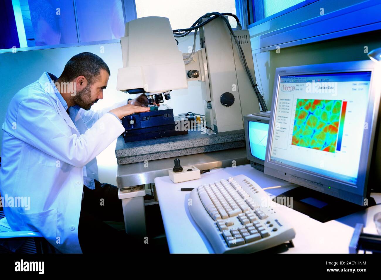 Skin research. Researcher using a microscope at the Laboratoire de ...