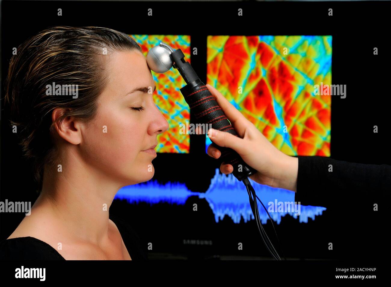 Skin research. Researcher using a handheld microscope to examine a ...