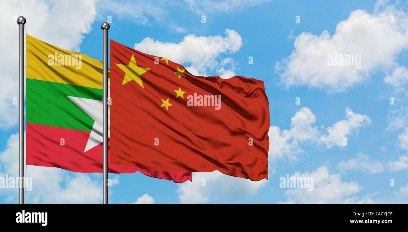 Myanmar and China flag waving in the wind against white cloudy blue sky ...